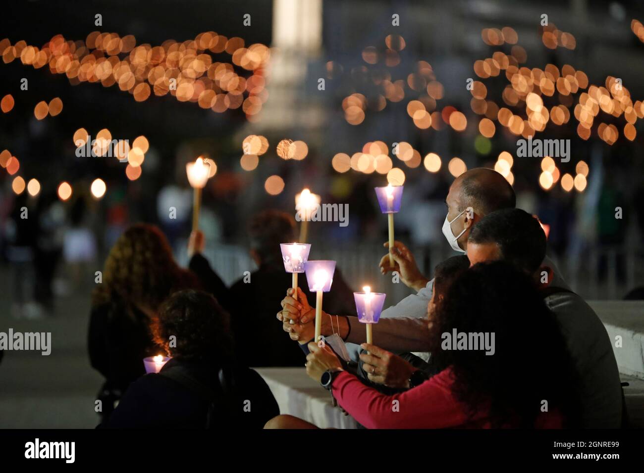 Worshippers with candles at evening mass during pilgrimage to Fatima ...