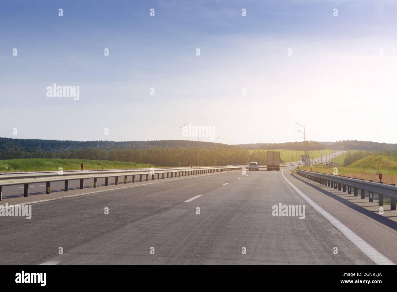 highway road in the countryside, roadside and asphalt, green forest and ...