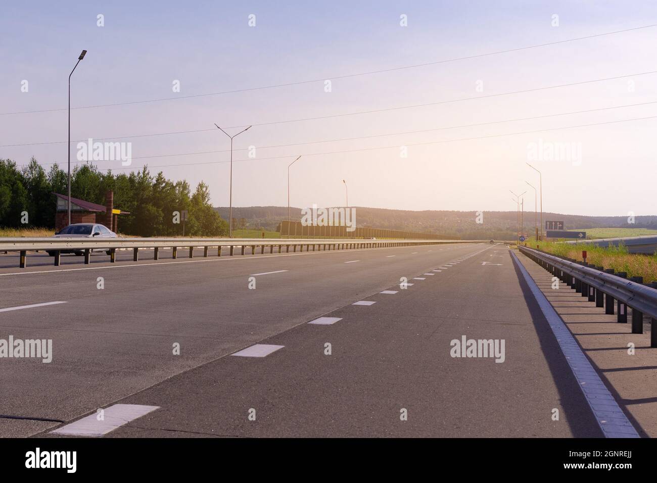 highway road in the countryside, roadside and asphalt, green forest and ...