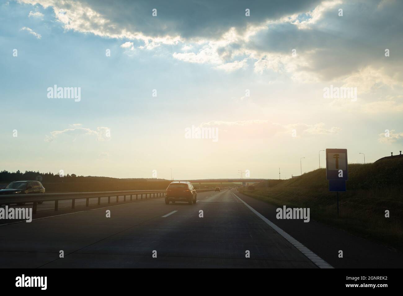 Evening sun view. Bridge on the highway, roadside and asphalt, in ...