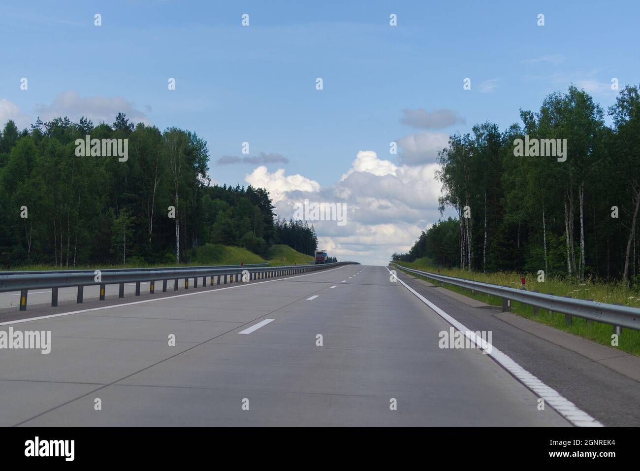 highway road in the countryside, roadside and asphalt, green forest and ...