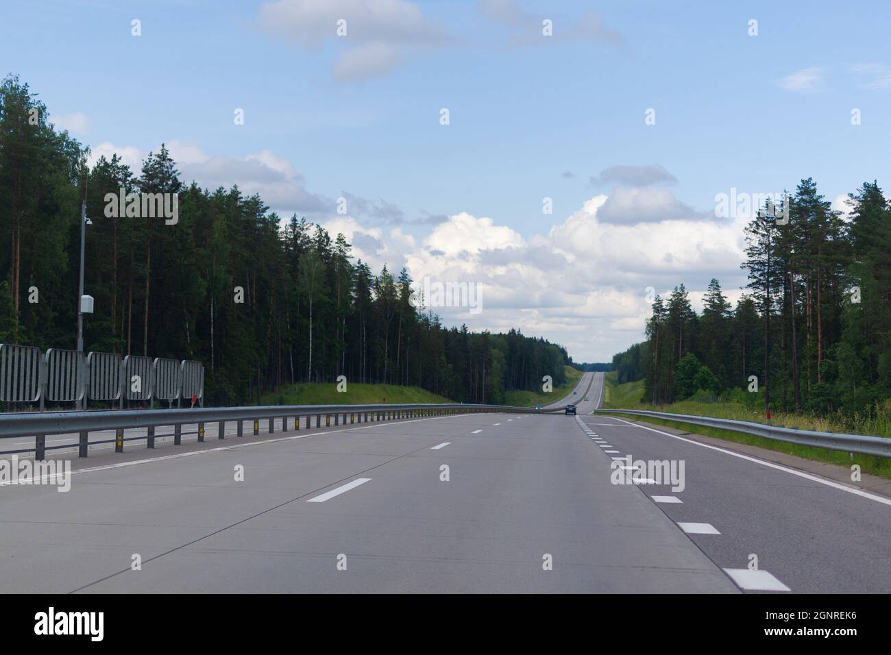 highway road in the countryside, roadside and asphalt, green forest and ...
