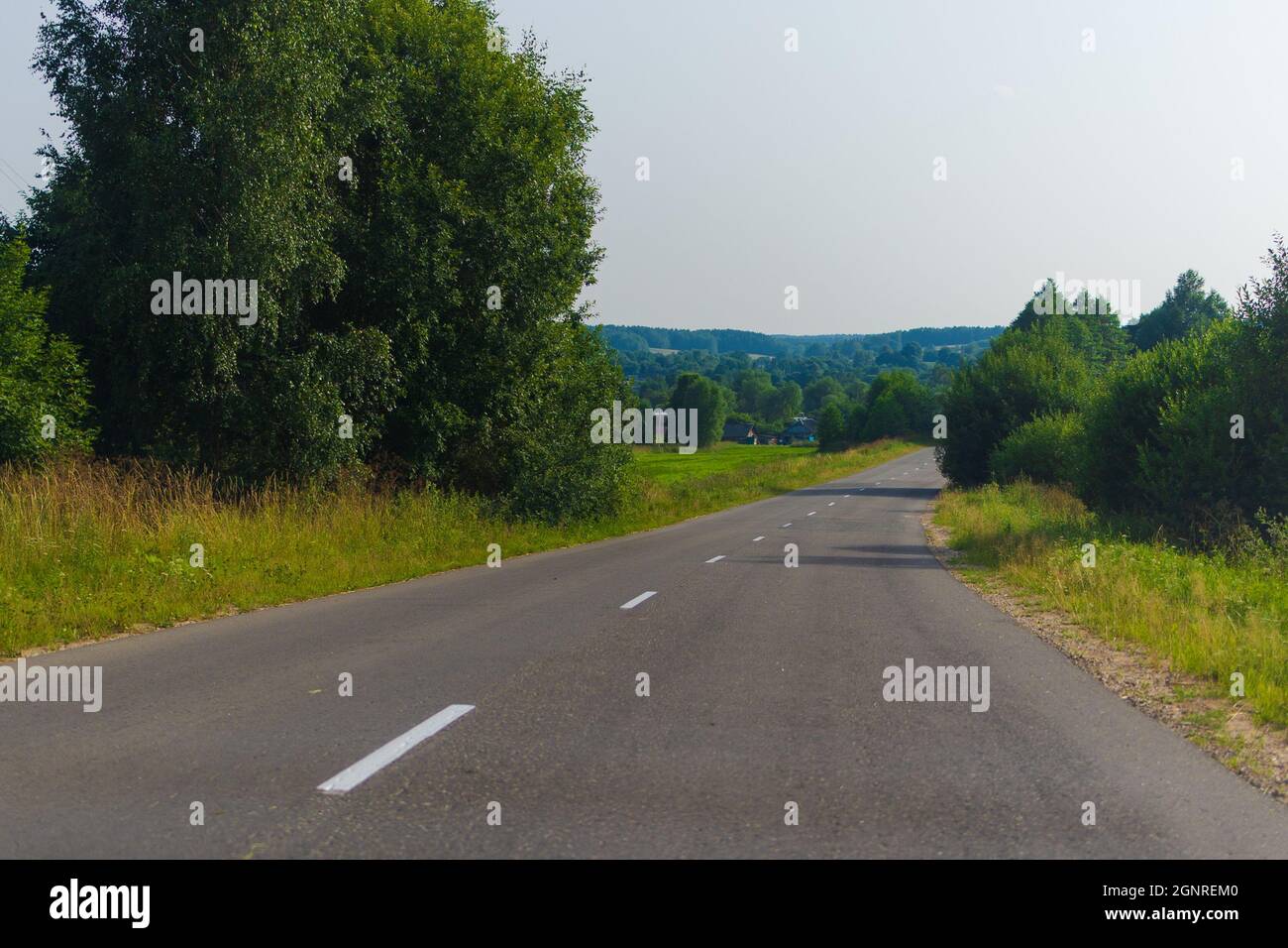 highway road in the countryside, roadside and asphalt, green forest and ...