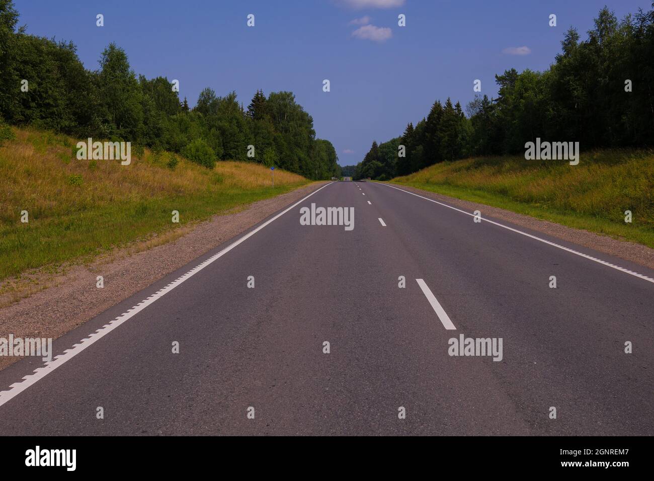 highway road in the countryside, roadside and asphalt, green forest and ...