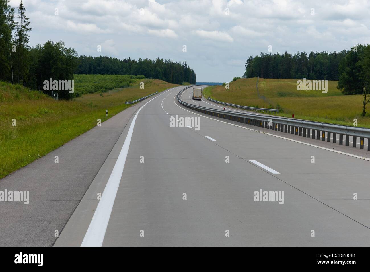 highway road in the countryside, roadside and asphalt, green forest and ...
