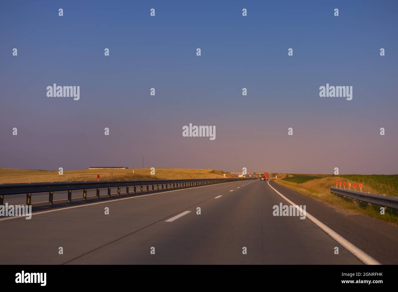 Evening sun view. Bridge on the highway, roadside and asphalt, in ...