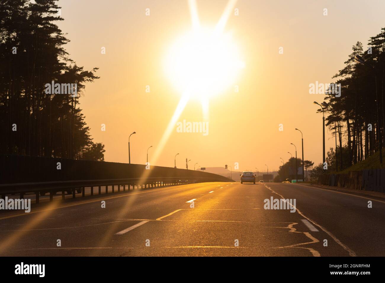 Evening sun view. Bridge on the highway, roadside and asphalt, in ...