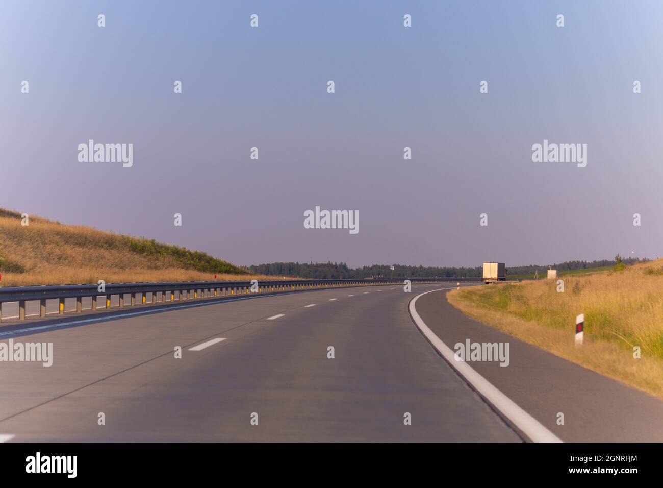 highway road in the countryside, roadside and asphalt, green forest and ...