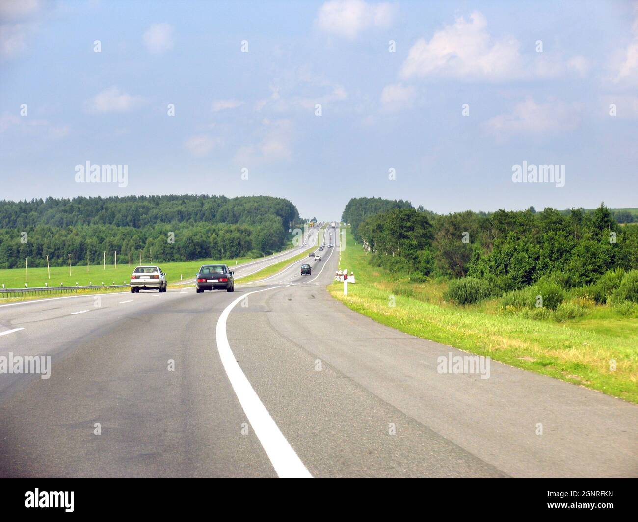 highway road in the countryside, roadside and asphalt, green forest and ...