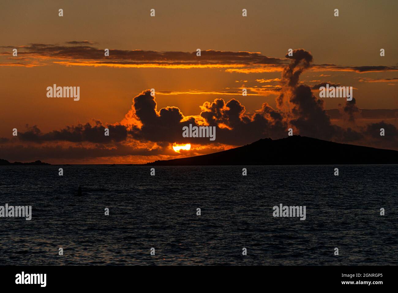 The sun setting behind Samson, Isles of Scilly Stock Photo - Alamy