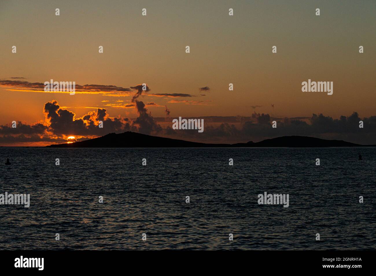The sun setting behind Samson, Isles of Scilly Stock Photo - Alamy