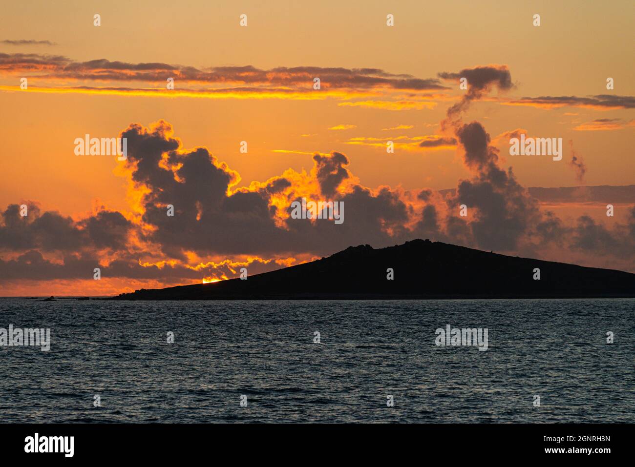 The sun setting behind Samson, Isles of Scilly Stock Photo - Alamy