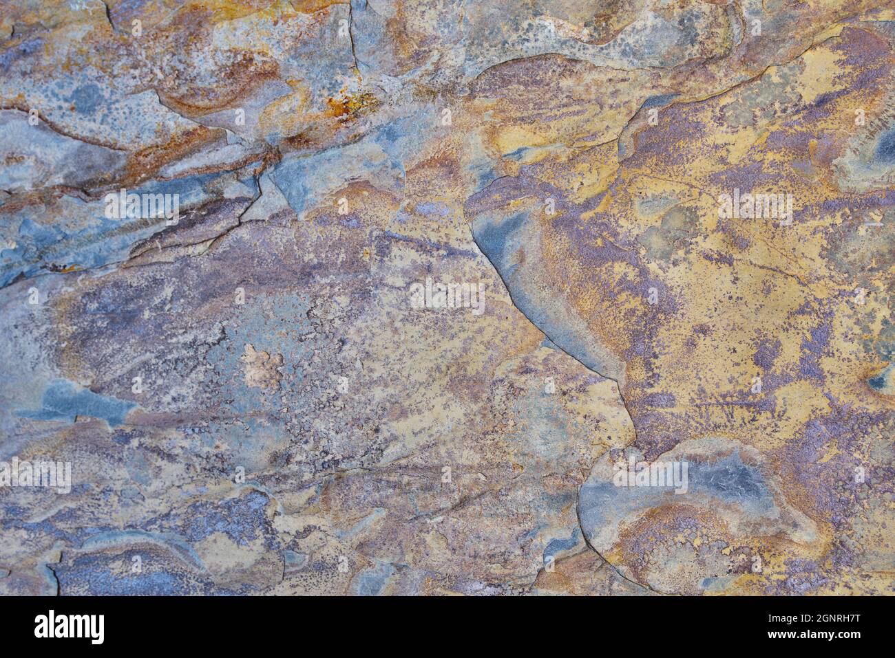 Rough stone texture with rust in blue and yellow colors with orang ...