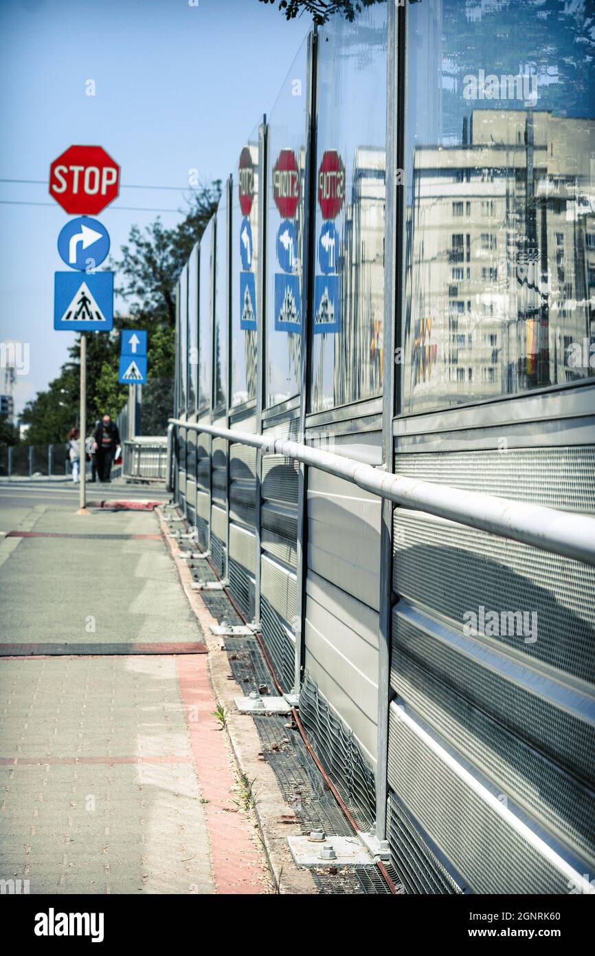 Street view with road traffic signs and partition wall with transparent ...