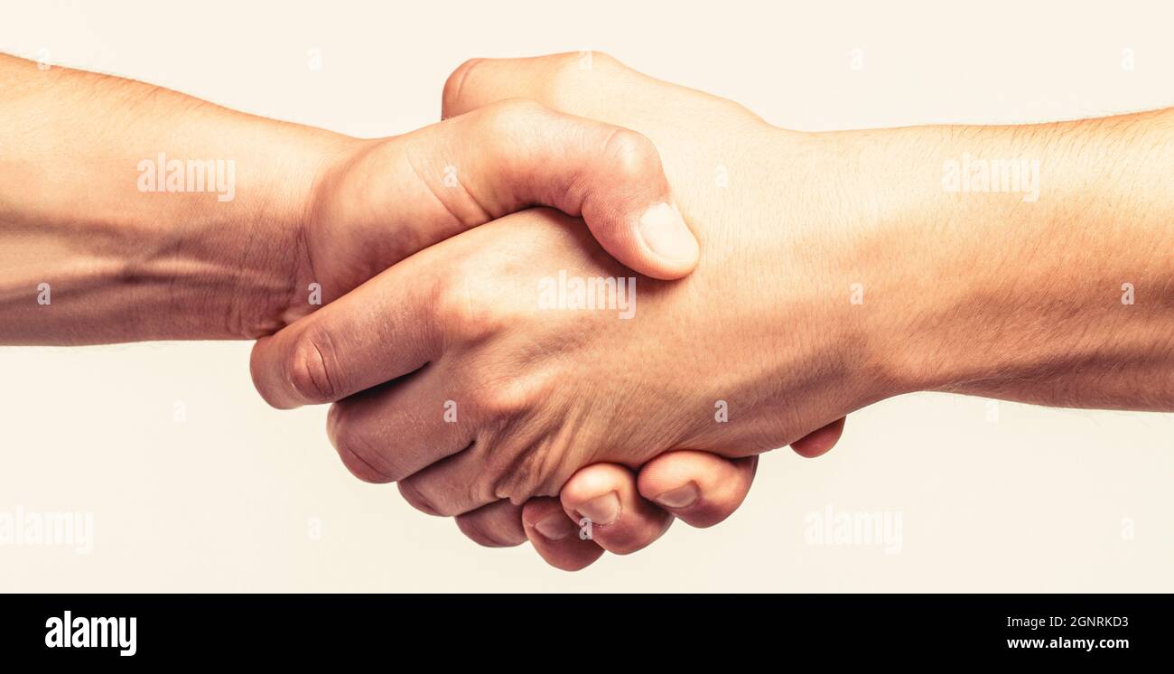 Friendly handshake, friends greeting, teamwork, friendship. Close-up. Rescue, helping gesture or ...