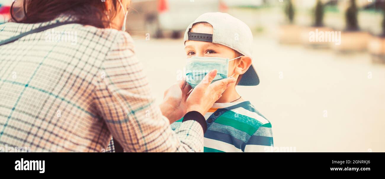 Mother puts on her son sterile medical mask. Mother, child wear ...