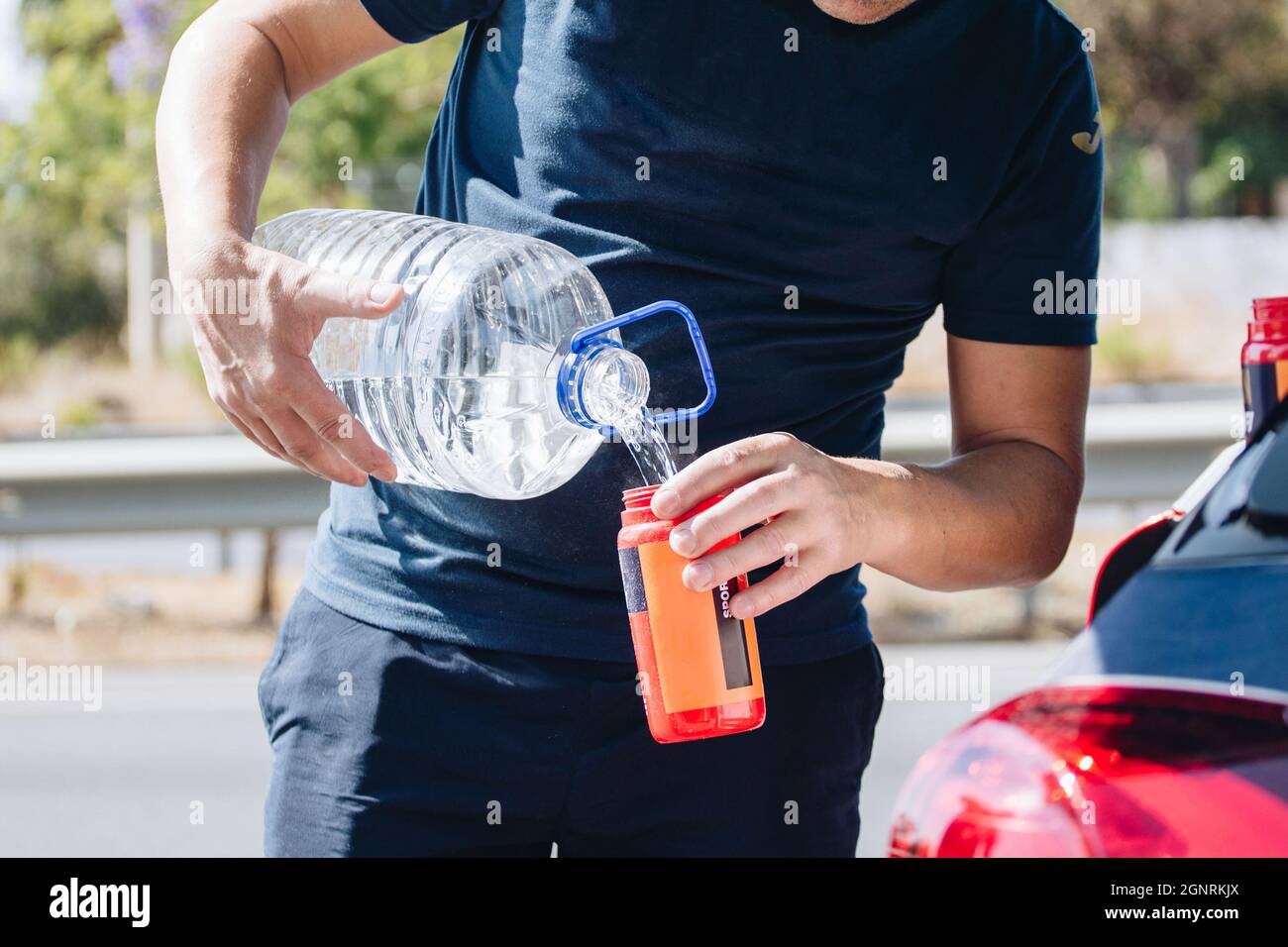 Closeup of the man pouring some water from the plastic bottle Stock ...