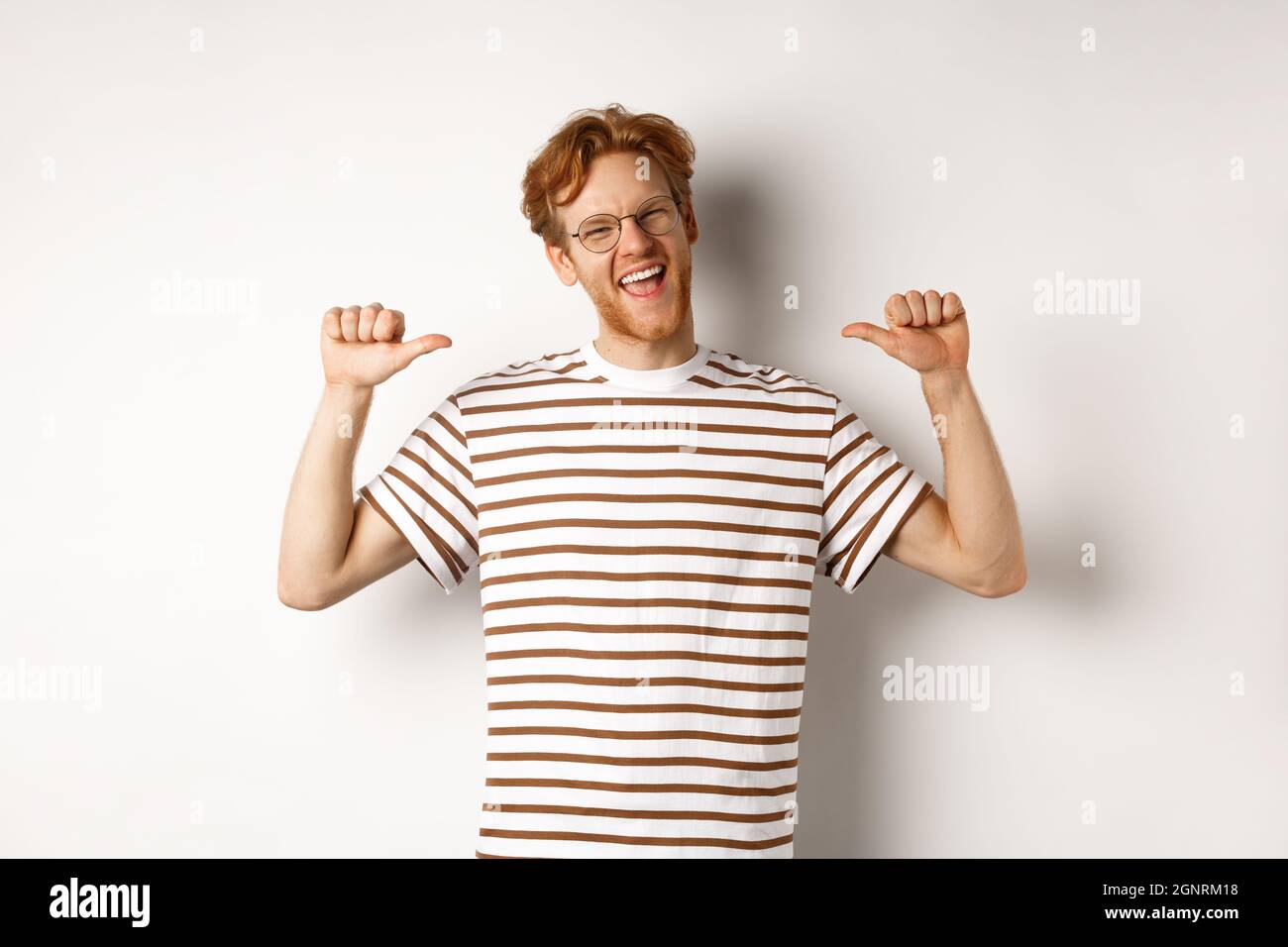 Cheerful and funny redhead man with beard, wearing glasses, laughing ...