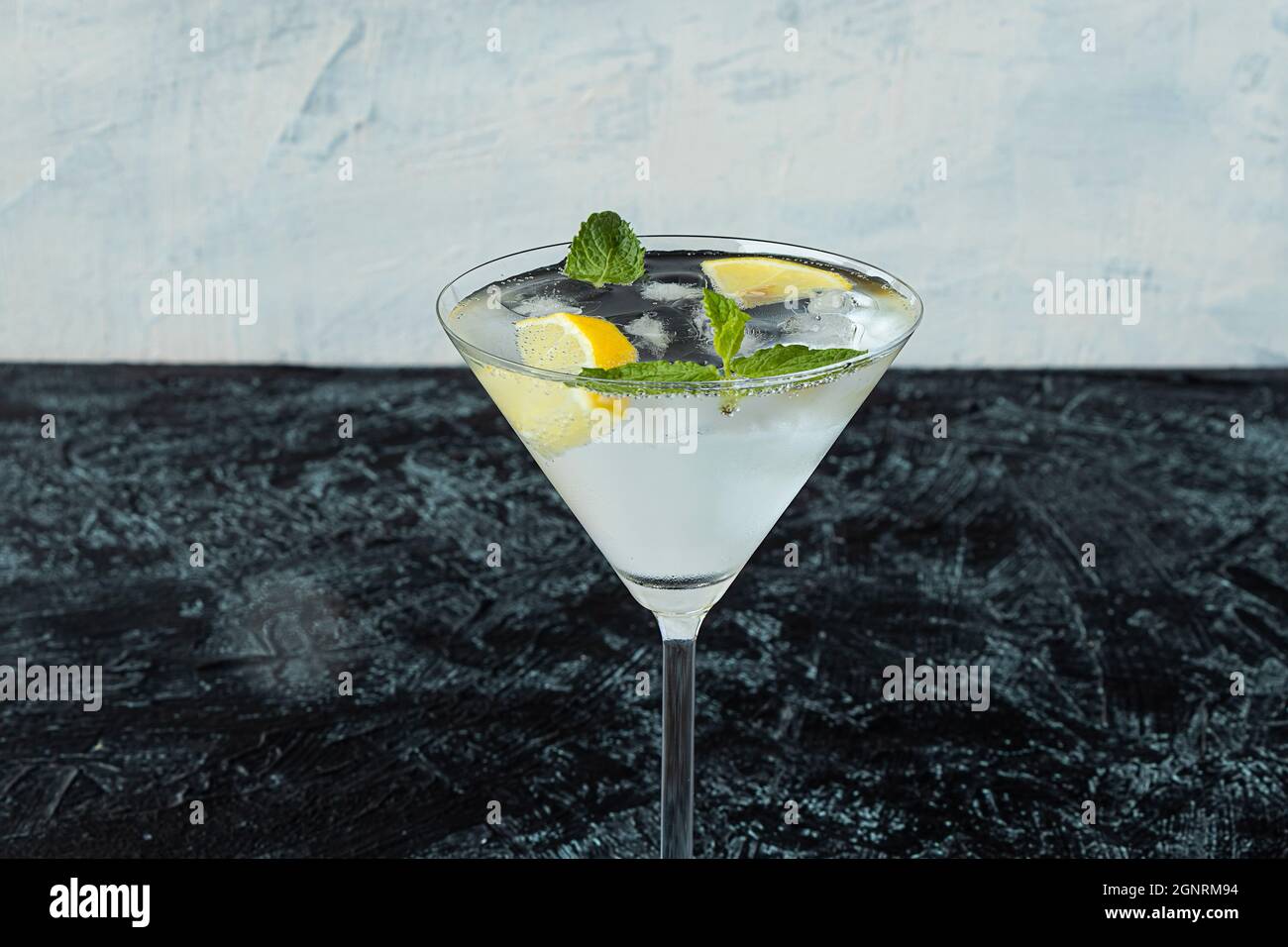 martini glass with cold drink on black and white background. refreshing ...