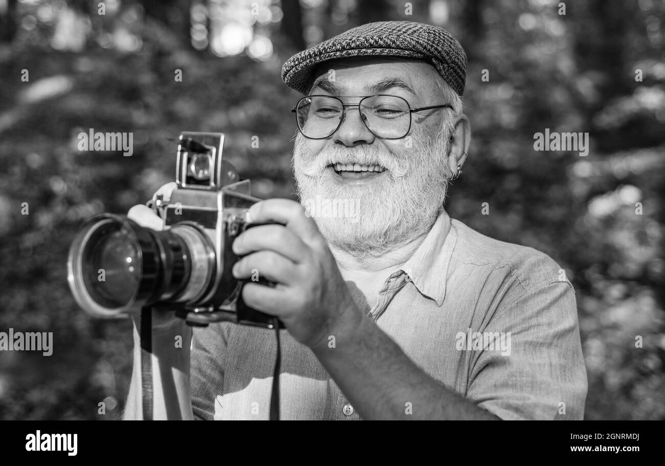 Landscape nature photo. Old photographer filming. Make perfect frame ...