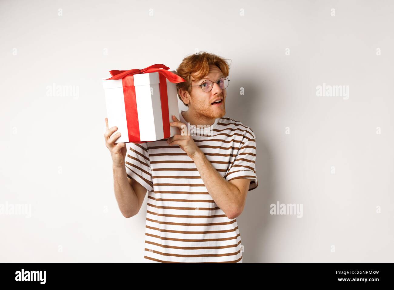 Valentines day and holidays concept. Intrigued young man trying to ...