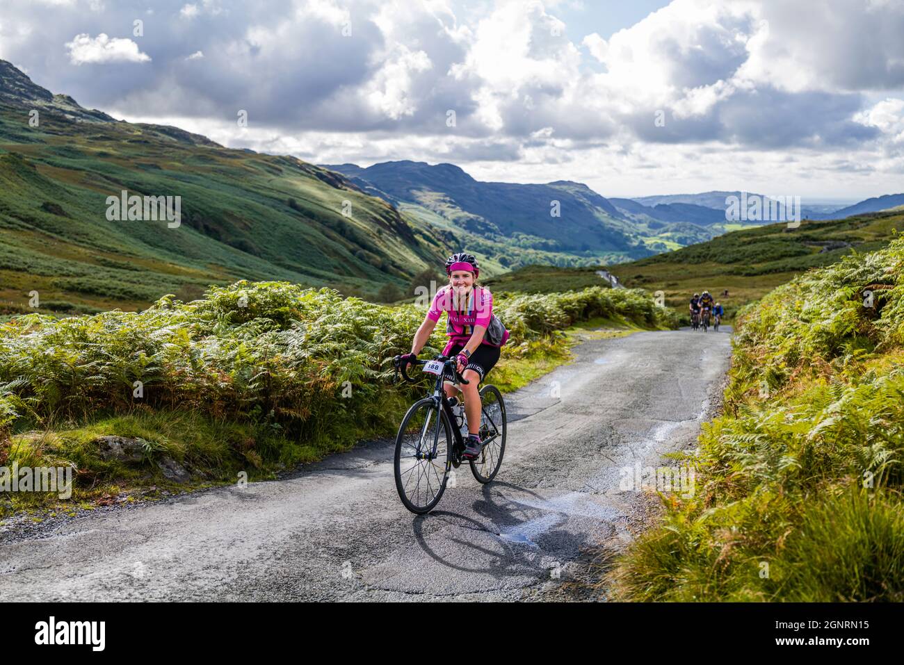 Female road cyclist in the Fred Whitton Challenge, Hardknott Pass ...