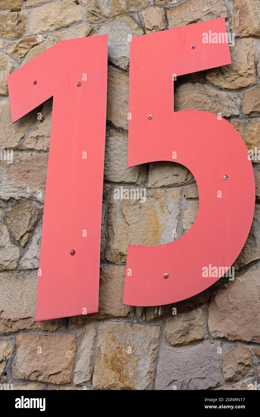 Big Red Number Fifteen at Stonw Wall Stock Photo - Alamy