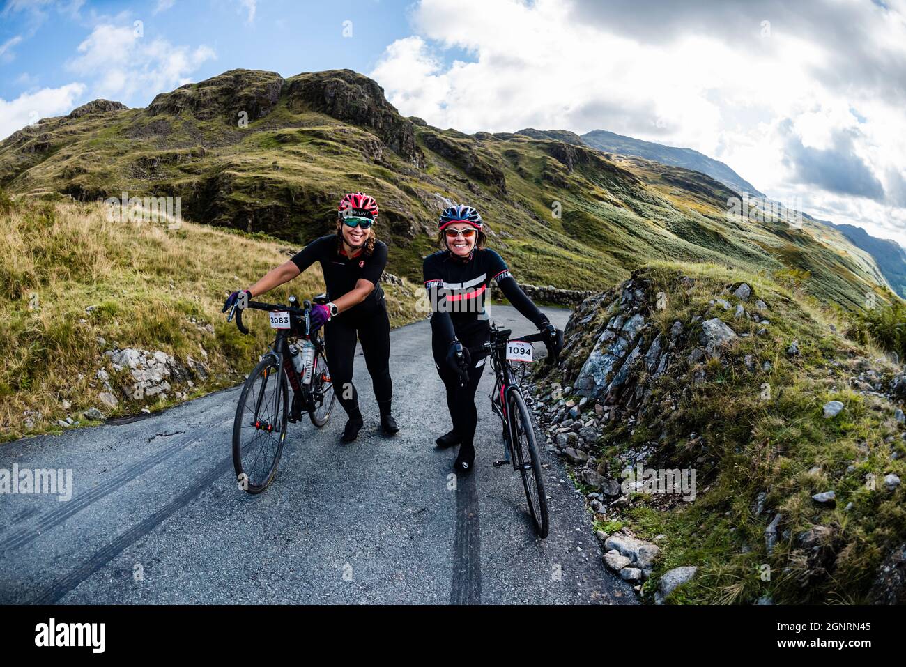 Two female road cyclists in the Fred Whitton Challenge, Hardknott Pass ...