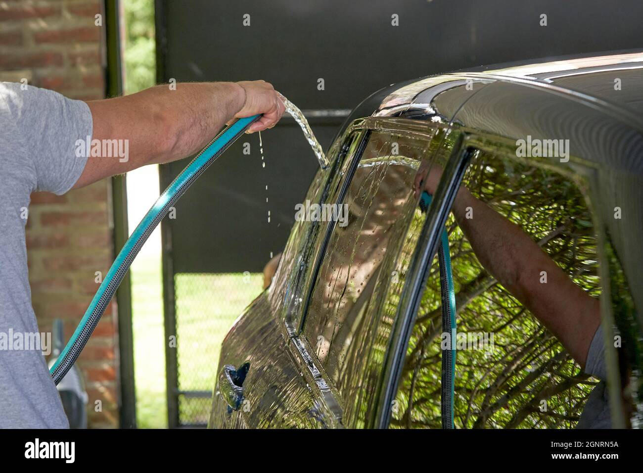 Car detailing. Manual car wash engine with water. Washing car engine ...