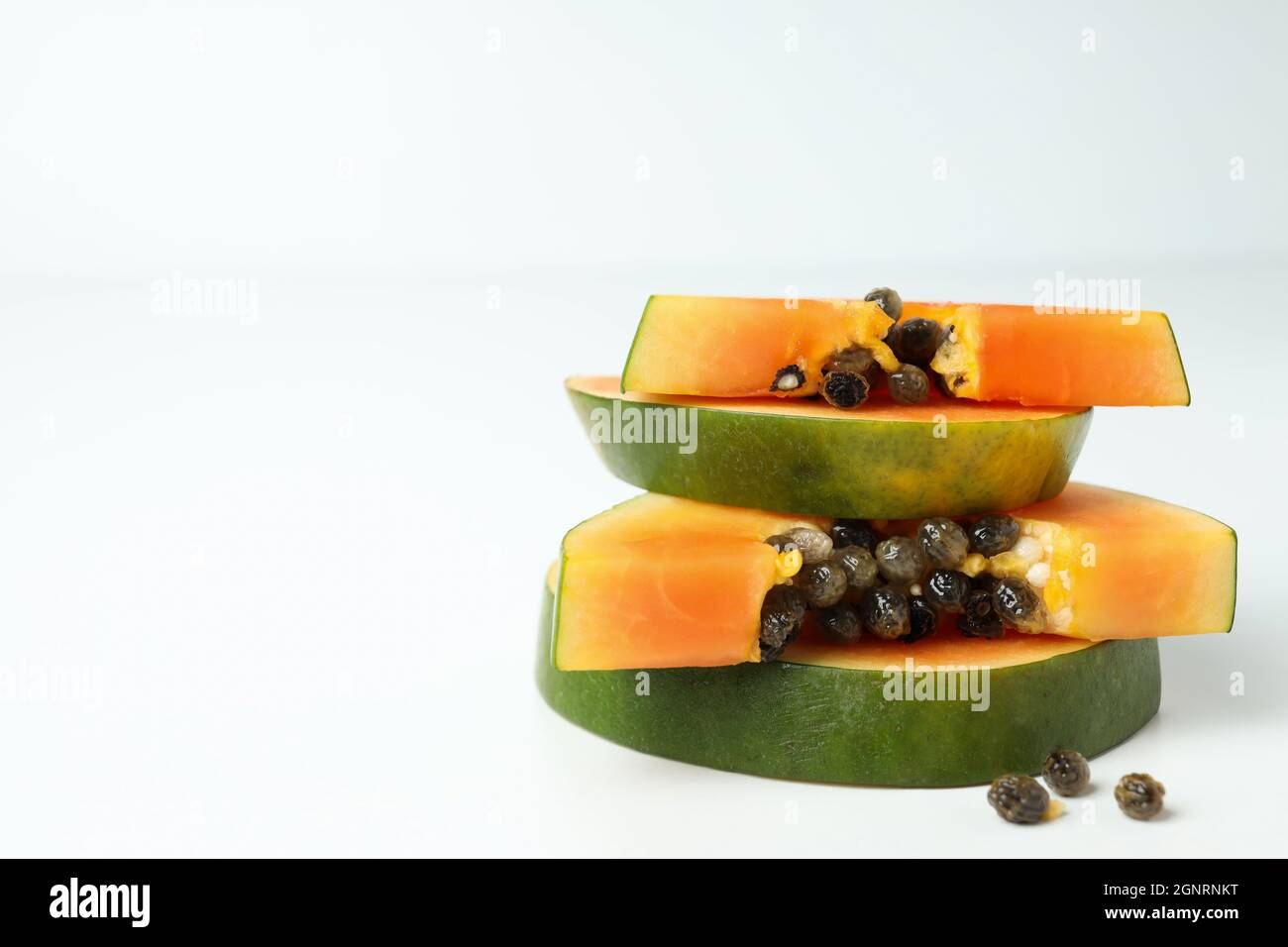 Fresh ripe papaya slices on white background Stock Photo - Alamy