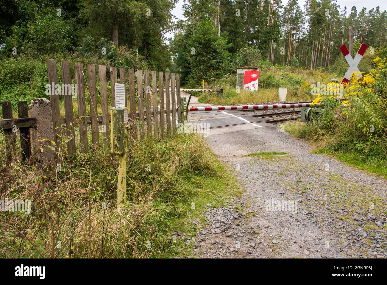 On-call railway crossing gate for hikers and rural traffic in a forest ...