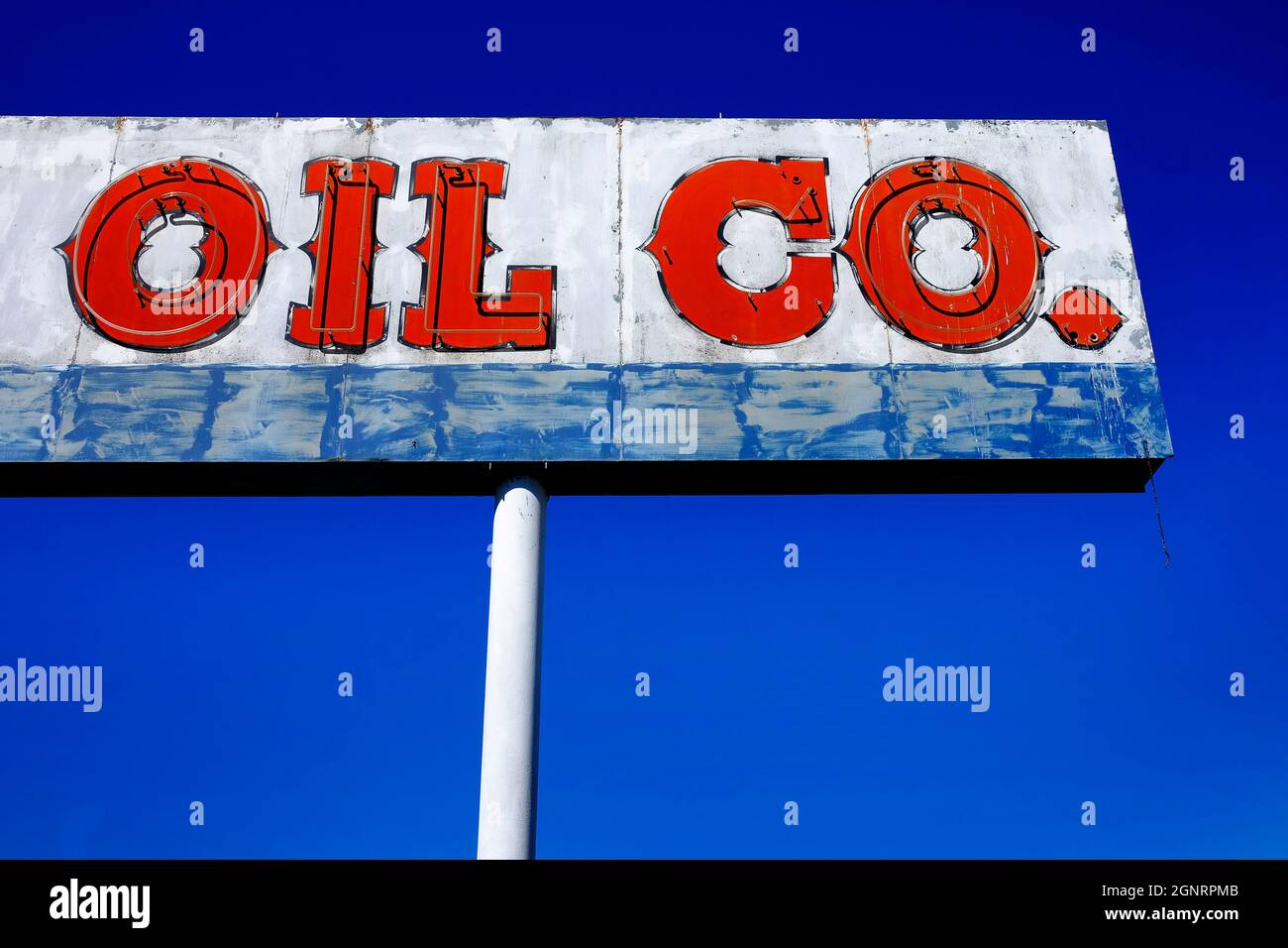 Old vintage oil company sign against blue sky on highway road Stock ...