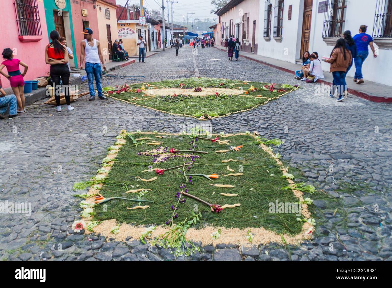ANTIGUA, GUATEMALA - MARCH 26, 2016: People walk along decorative ...