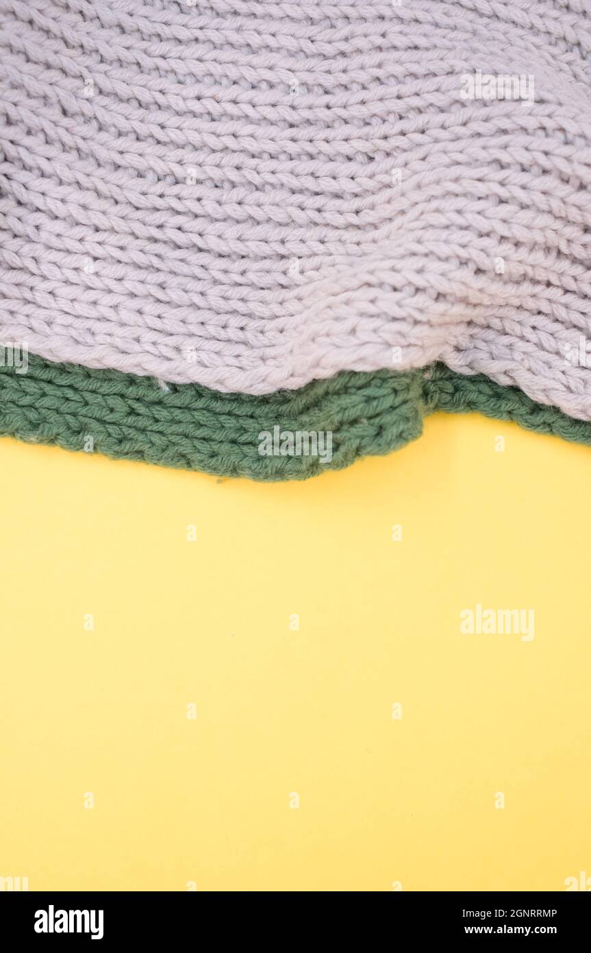 knitted soft natural wool scarf on a light yellow background Stock ...