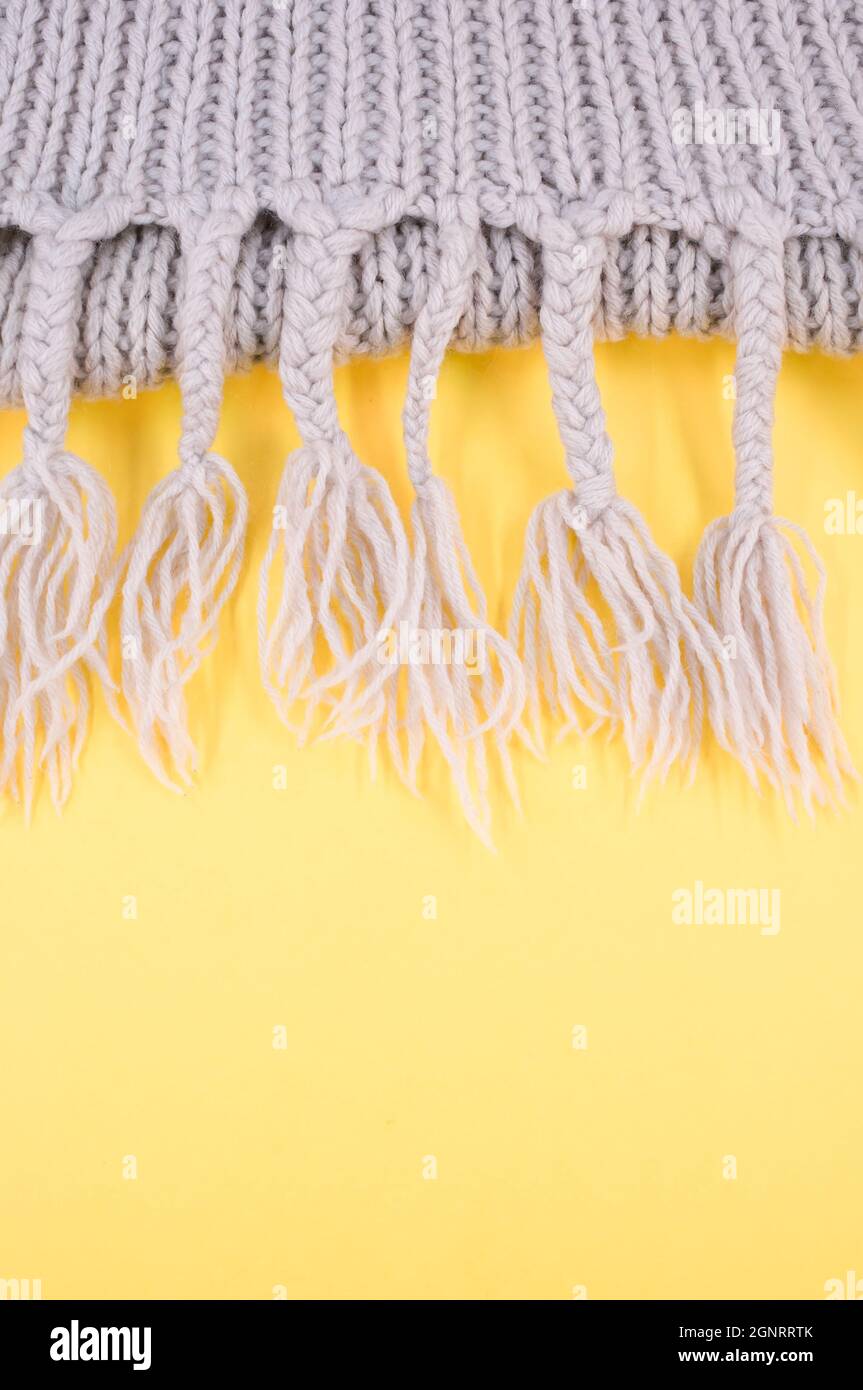 knitted soft natural wool scarf on a light yellow background Stock ...