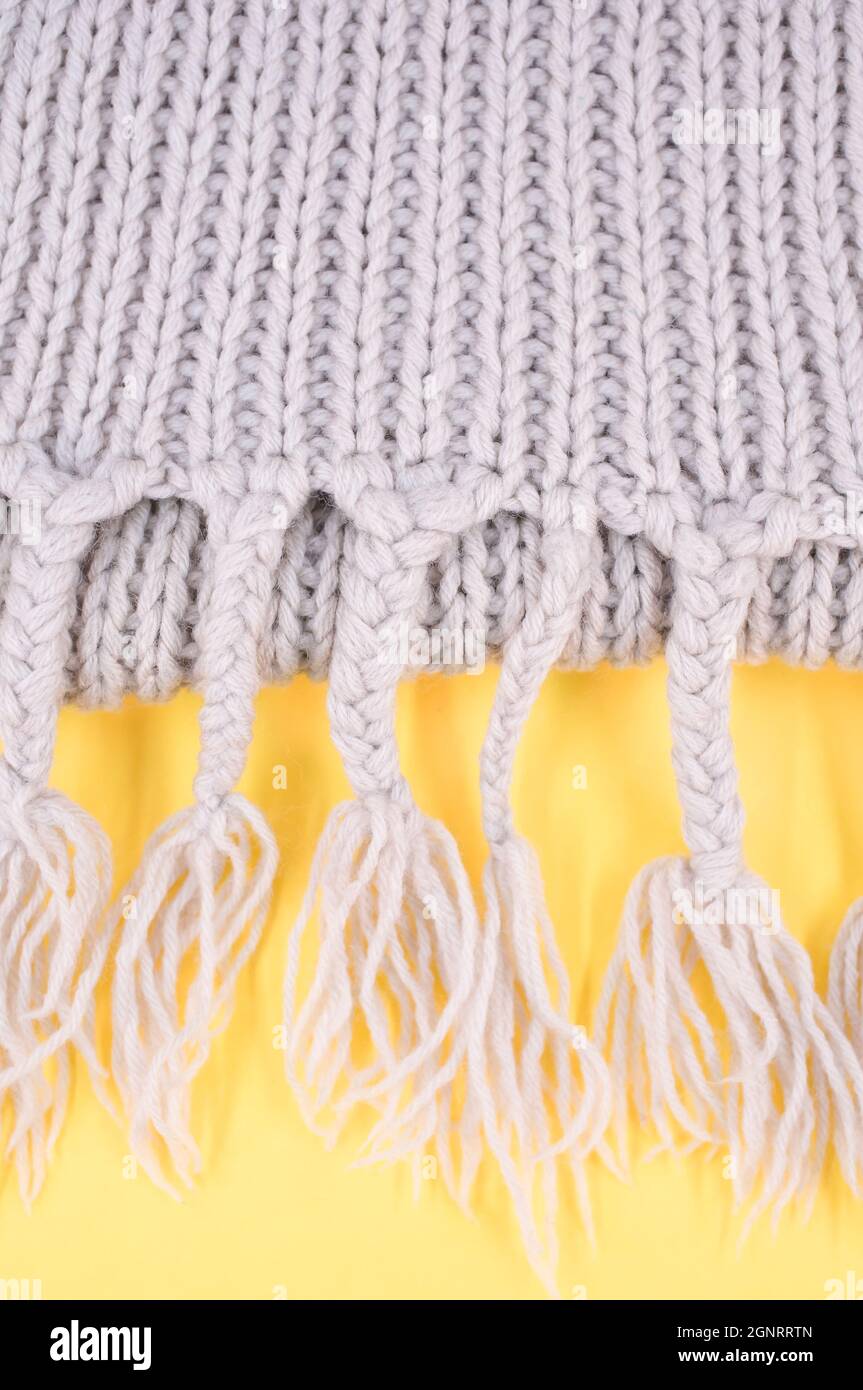 knitted soft natural wool scarf on a light yellow background Stock ...