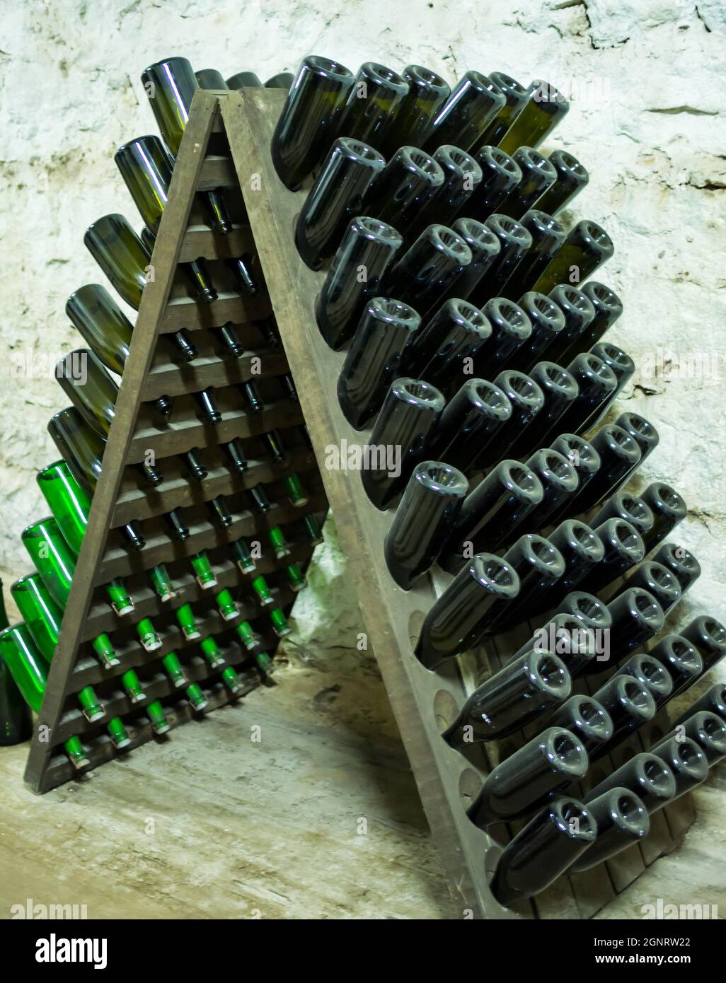 Rack for the process of remuage of champagne bottles Stock Photo - Alamy