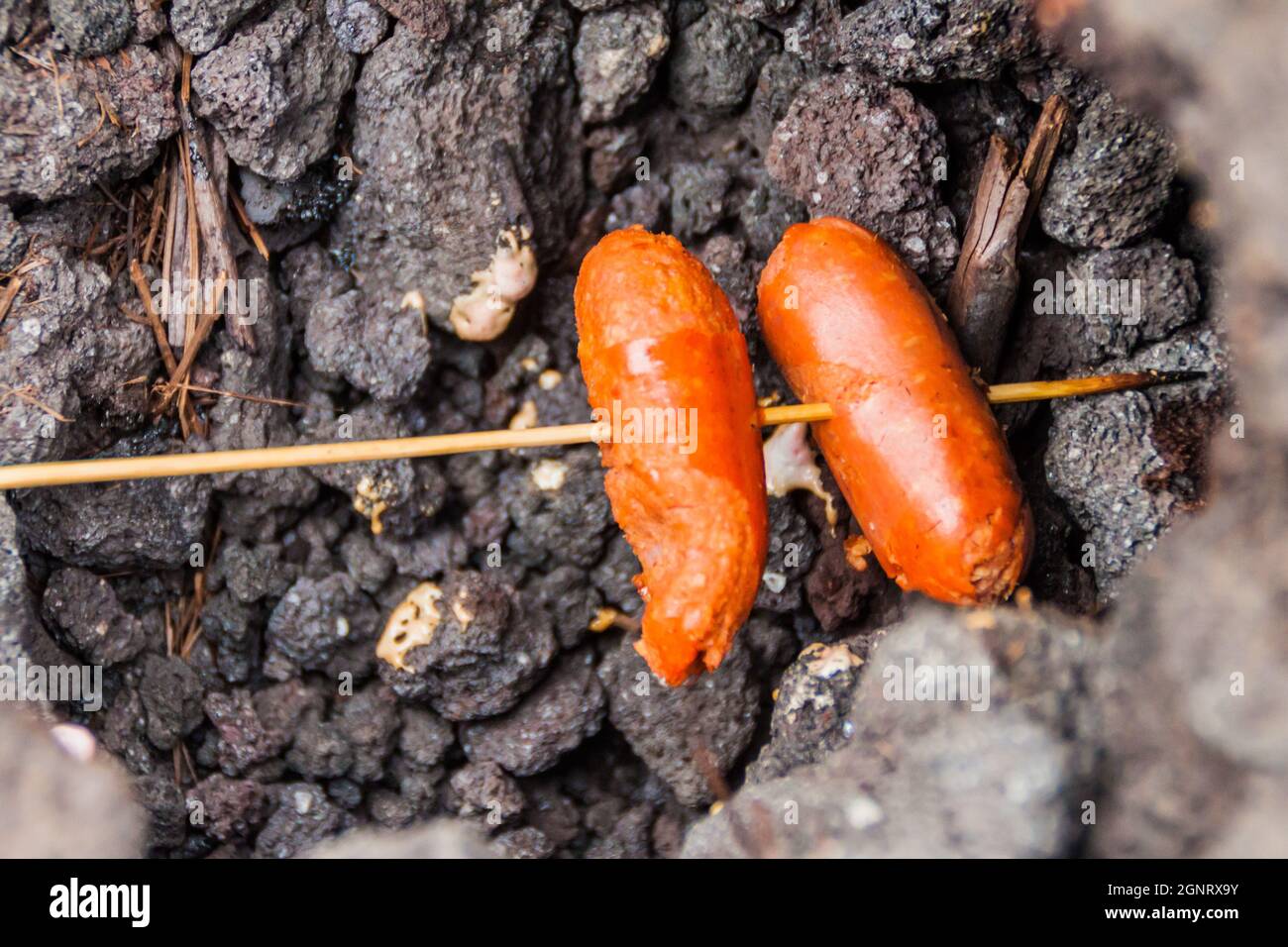Roasting sausages at the lava field of Pacaya volcano, Guatemala Stock ...