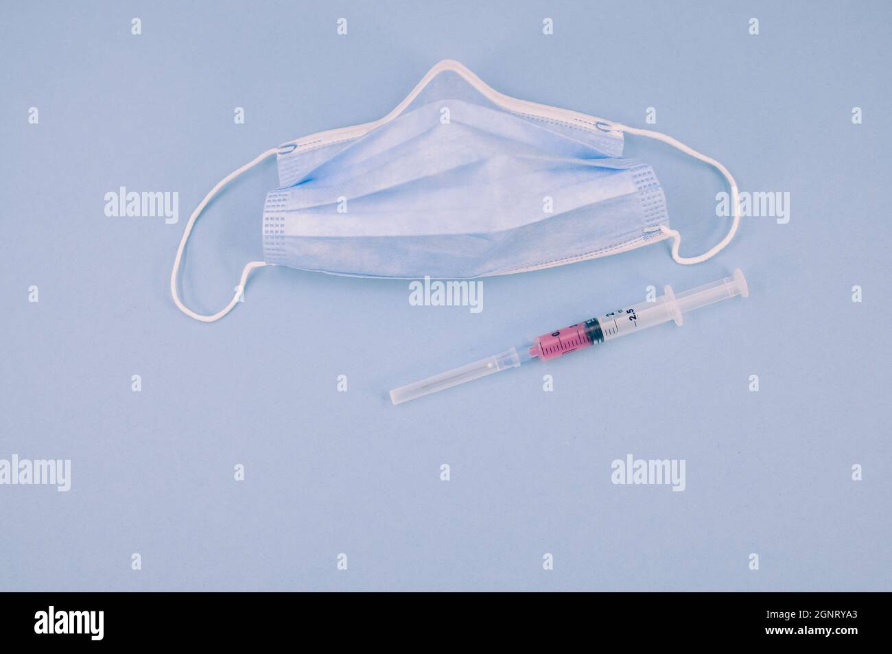 Isolated respiratory mask and syringe on a blue background Stock Photo ...