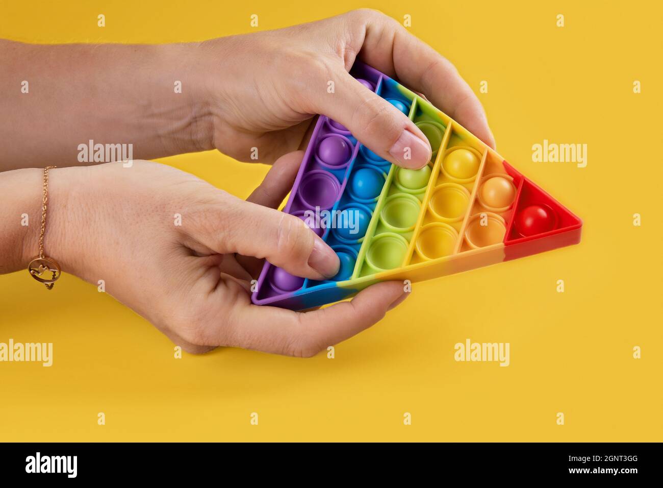 Female hans using rainbow popit toy antistress for children and adults ...