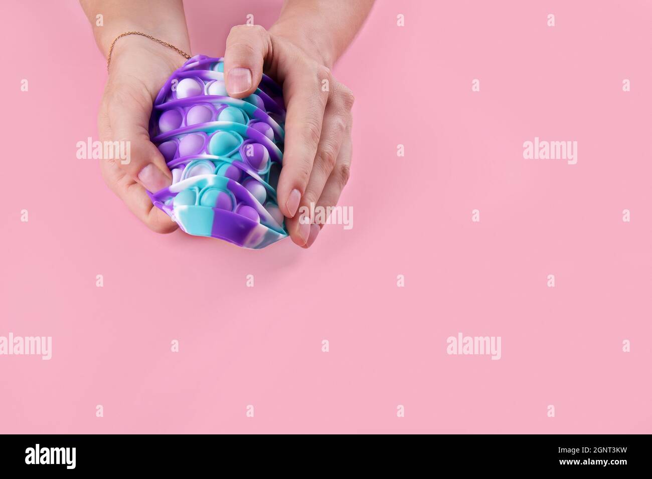 Female hans using pastel color round popit toy antistress for children ...