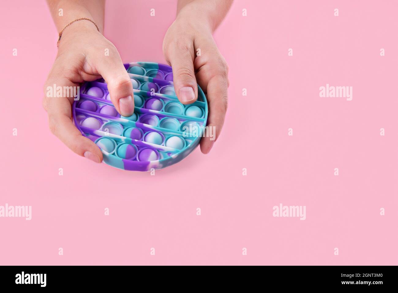 Female hans using pastel color round popit toy antistress for children ...