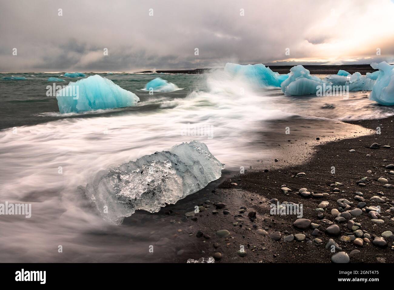 amazing blue colored icebergs washed ashore the black sand beach ...