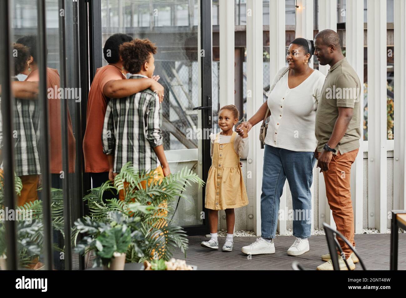 Full length portrait of happy multi-generational family chatting during ...