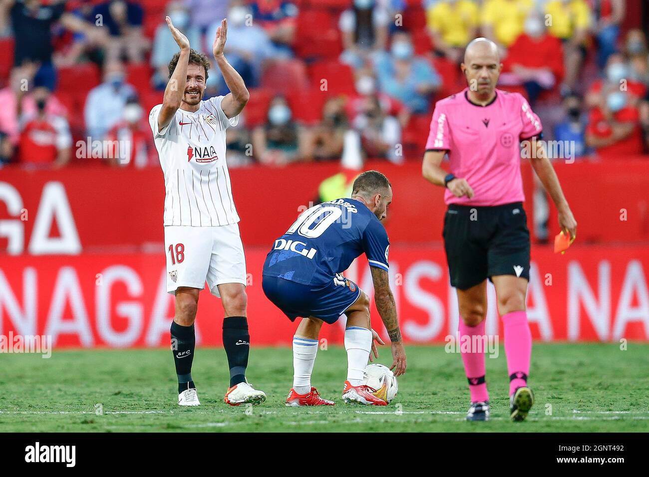 The referee Pablo Gonzalez Fuertes and Tomas Delaney of Sevilla FC ...