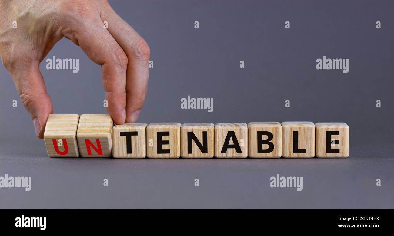 Tenable or untenable symbol. Businessman turns cubes and changes the ...