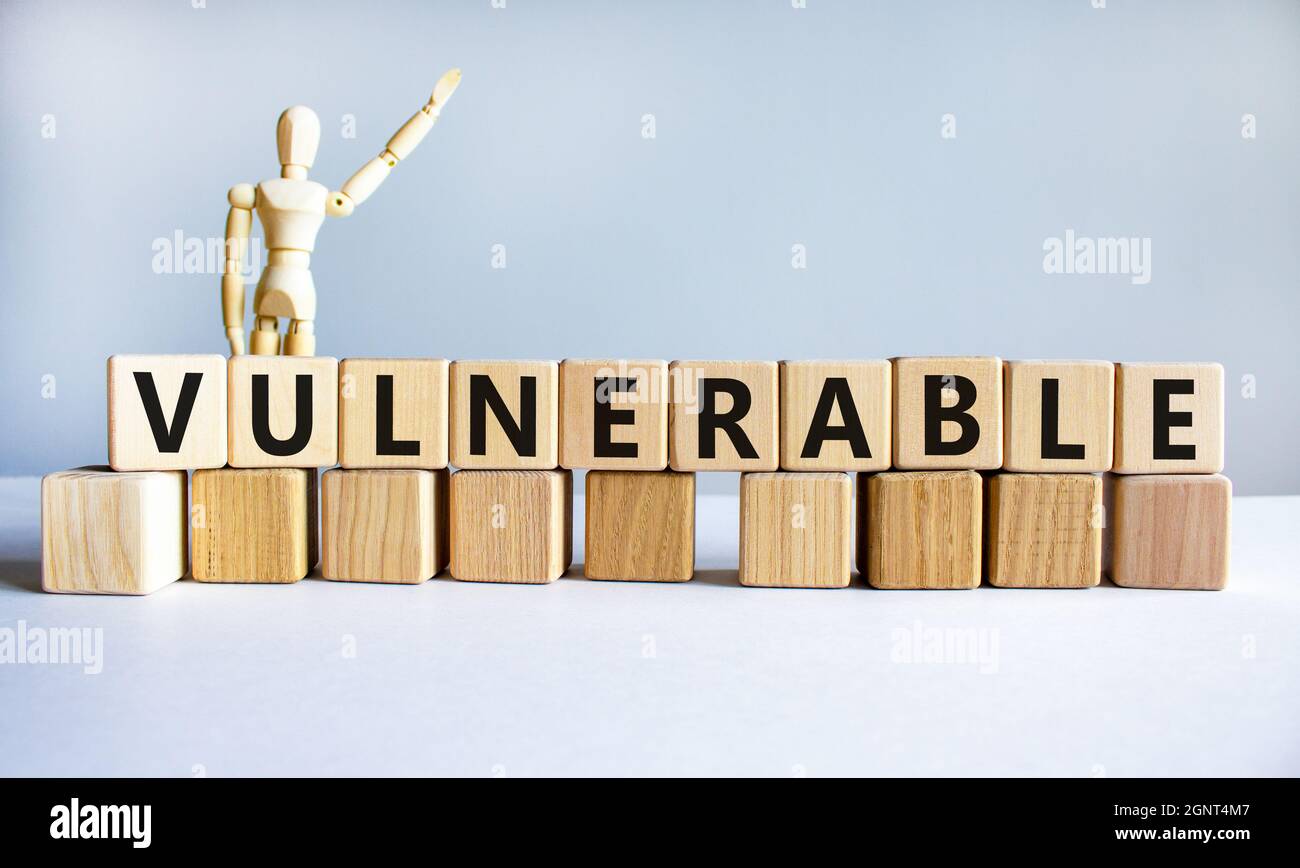 Vulnerable symbol. The word Vulnerable on wooden cubes. Wooden model of ...