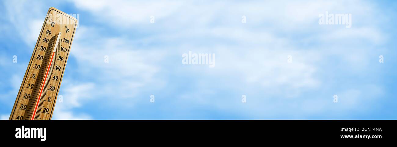 Wooden thermometer with red measuring liquid showing high temperature ...