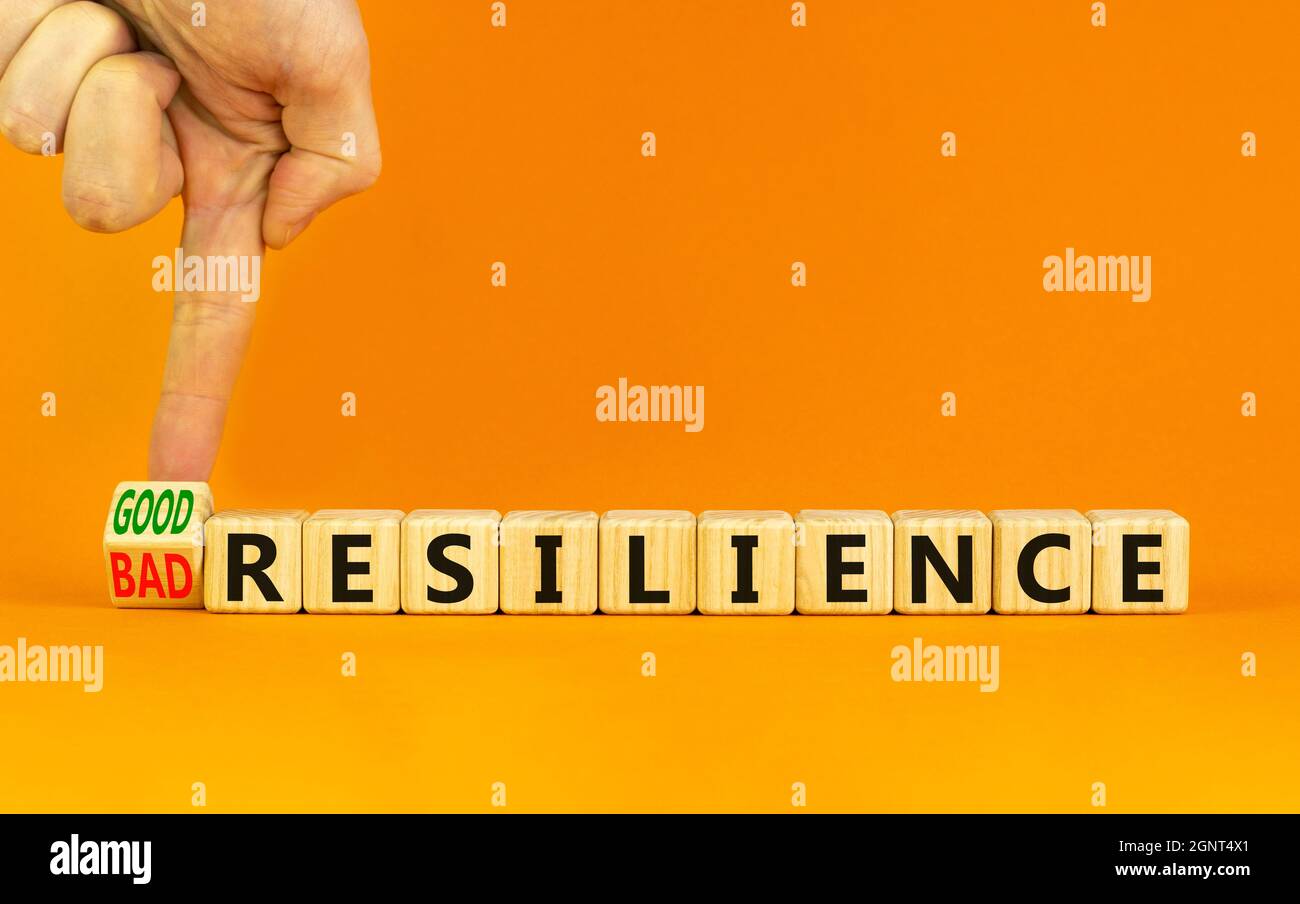 Good or bad resilience symbol. Businessman turns a wooden cube, changes ...