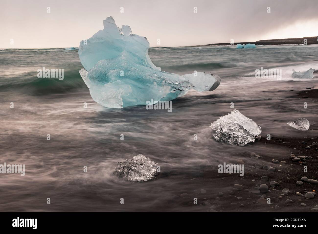 amazing blue colored icebergs washed ashore the black sand beach ...